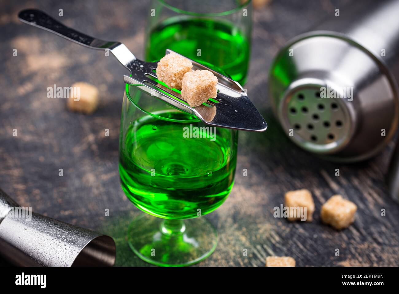 Glass of absinthe with cane sugar Stock Photo - Alamy