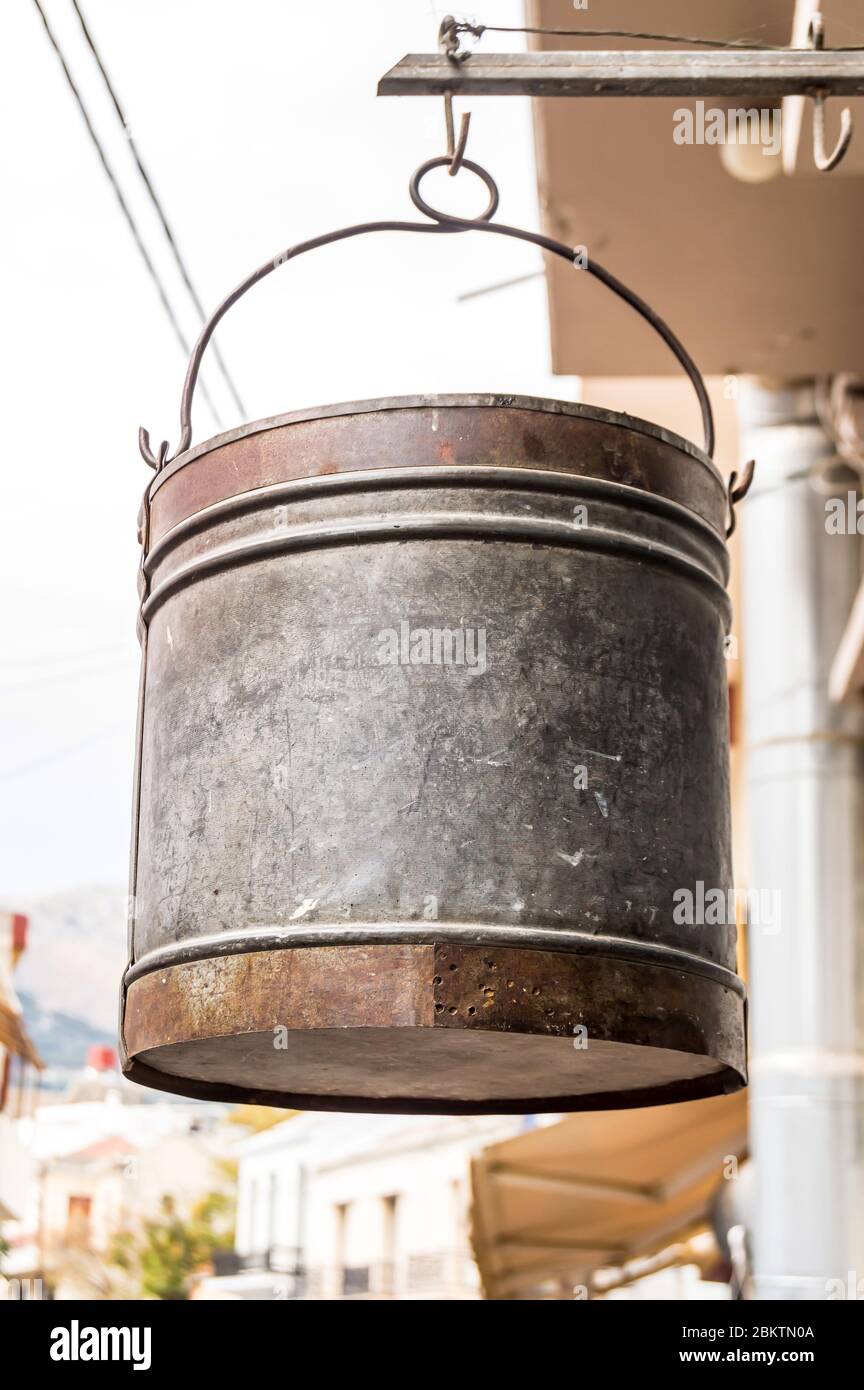 Scrap bucket hanging outside by a hook Stock Photo - Alamy