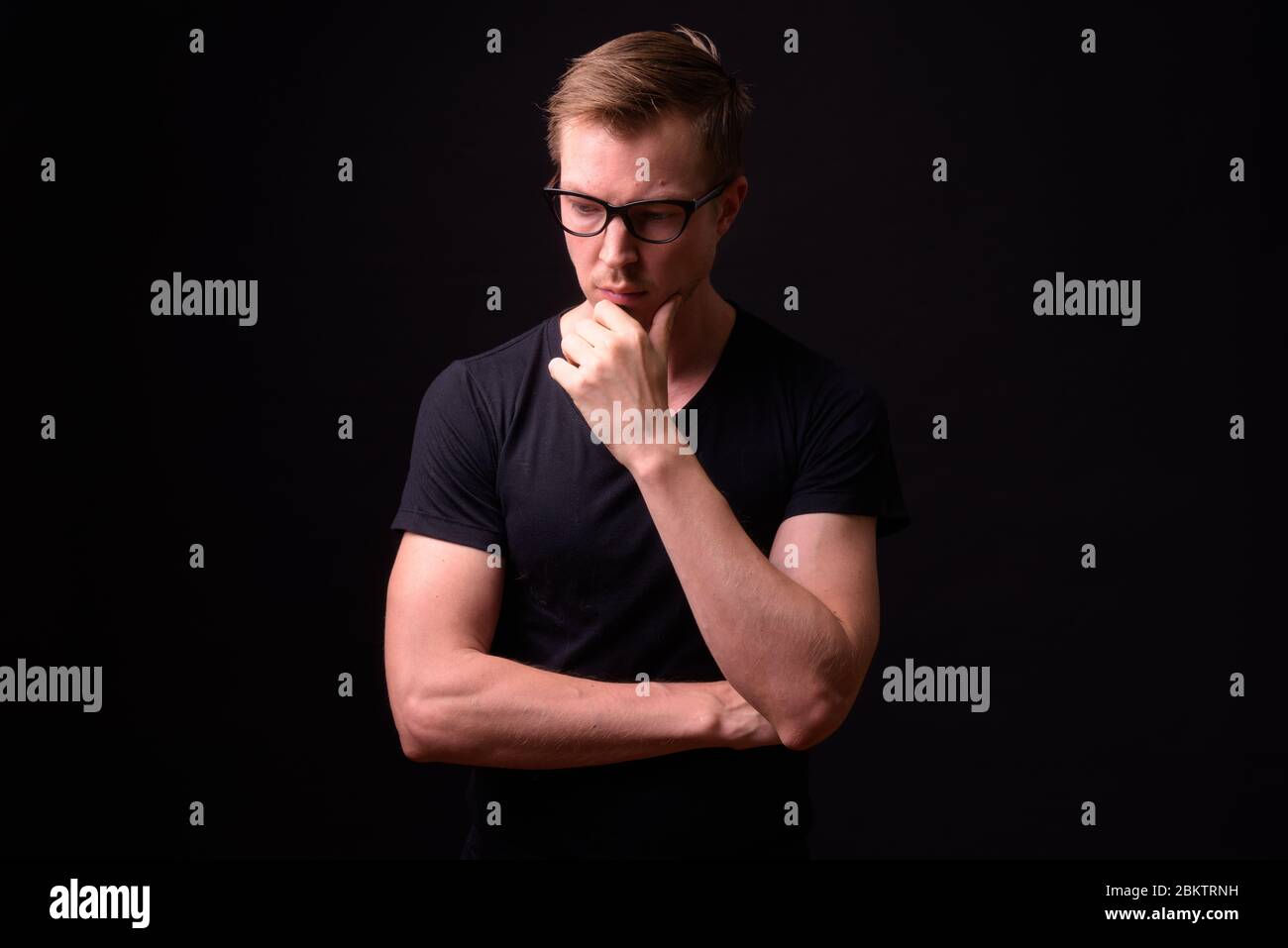 Portrait of stressed young nerd man with eyeglasses thinking and ...