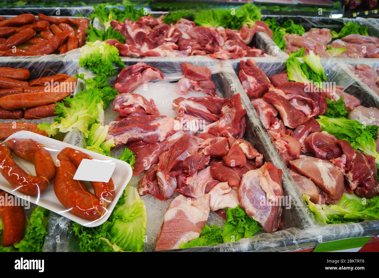 Meat department shelves with typical raw meat. Close-up of meat in ...