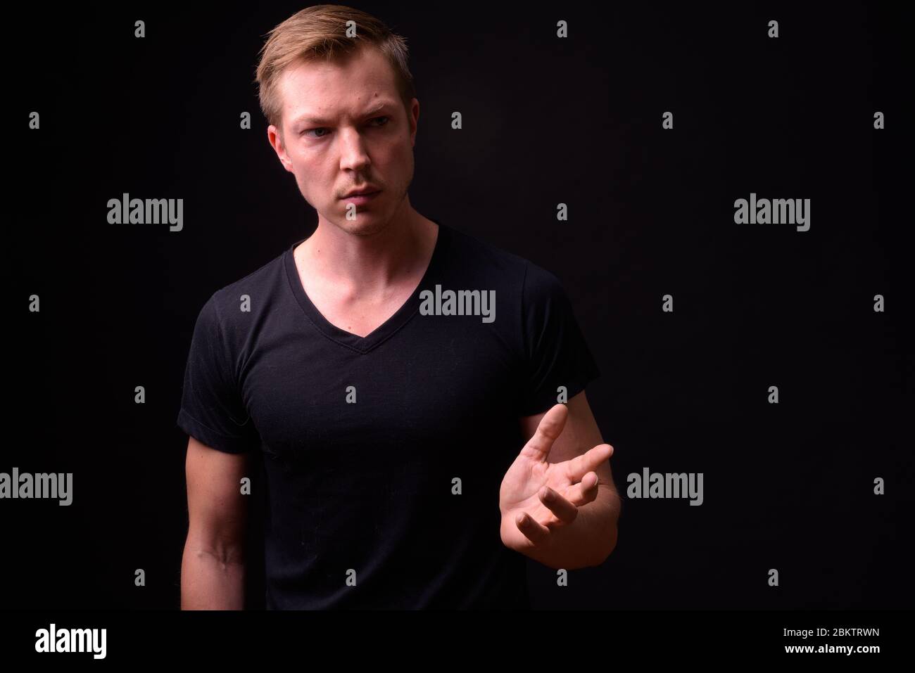 Portrait of stressed young man gesturing and explaining something Stock ...