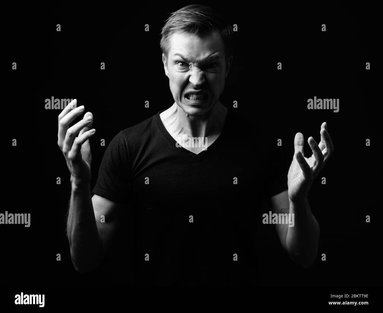 Portrait of stressed young man looking angry and in rage Stock Photo ...