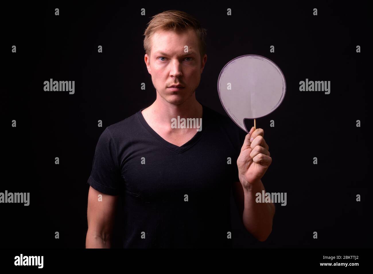 Portrait of young handsome man holding paper sign Stock Photo - Alamy