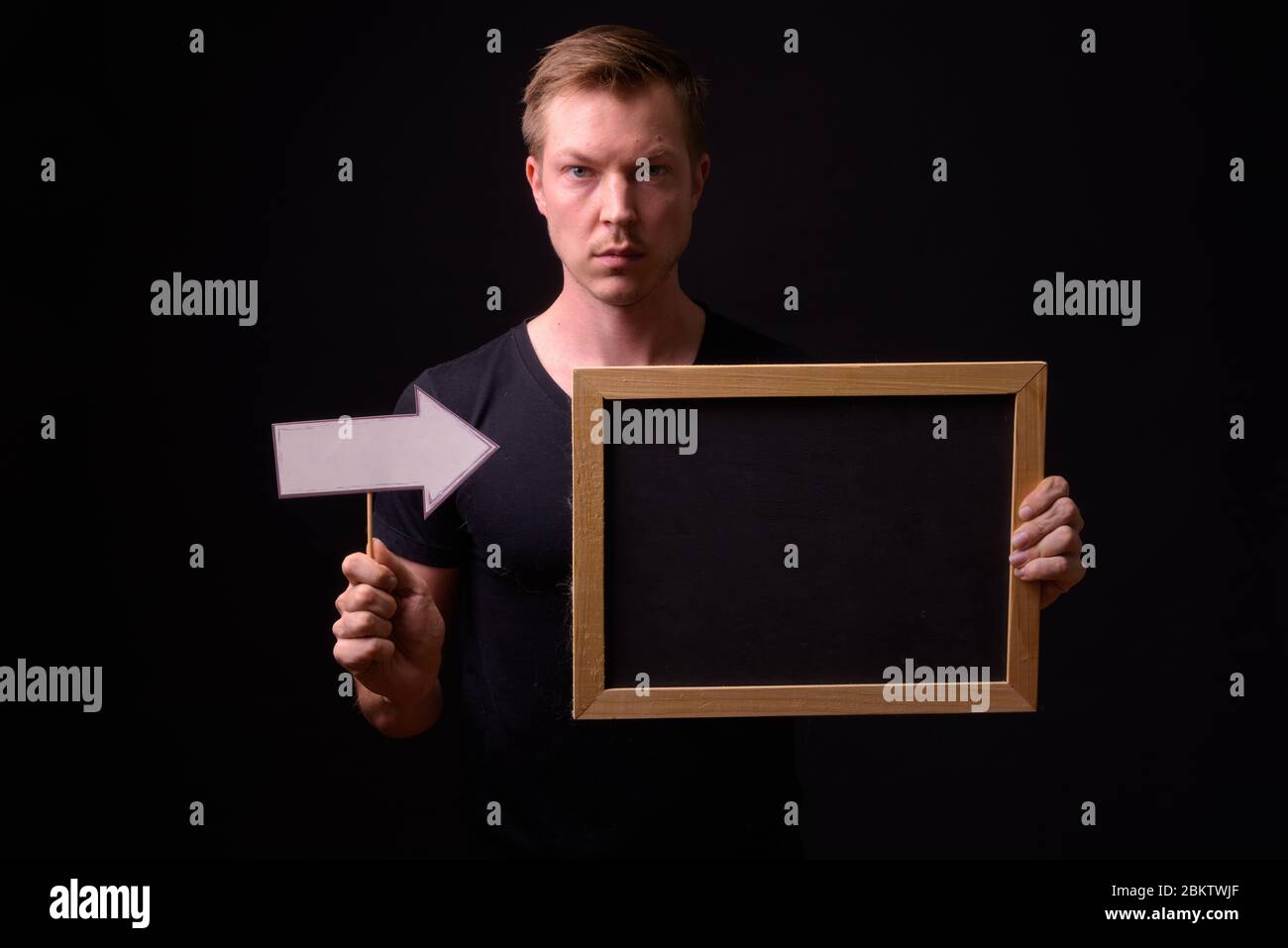 Man with arrow sign hi-res stock photography and images - Alamy