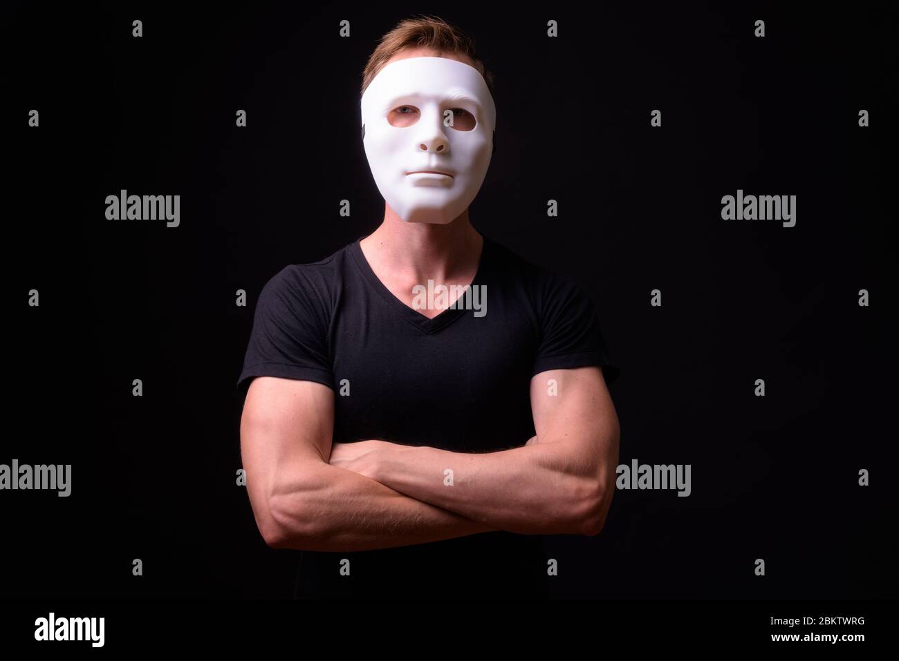 Portrait of young man wearing white mask Stock Photo - Alamy