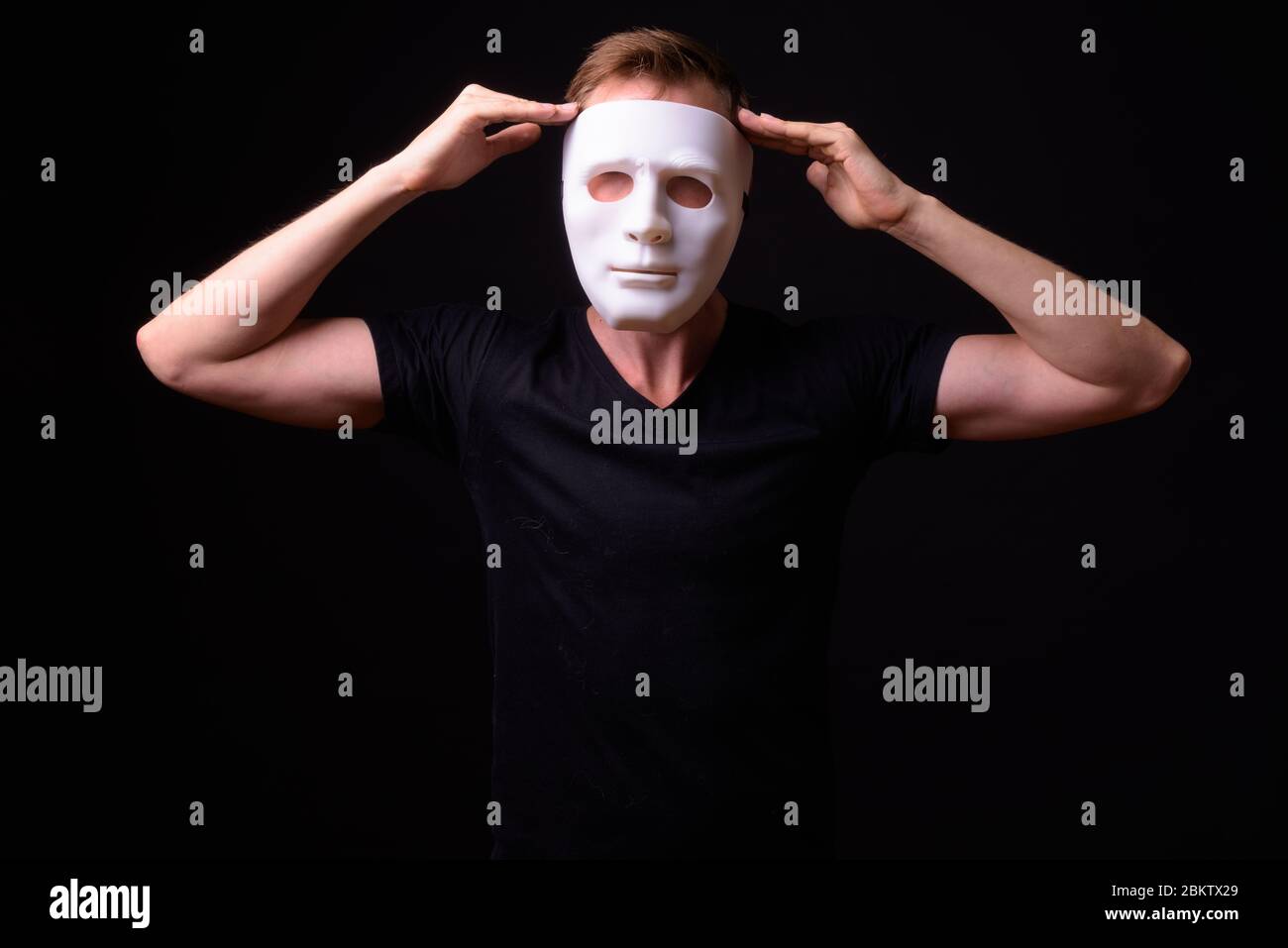 Portrait of young man wearing white mask Stock Photo - Alamy