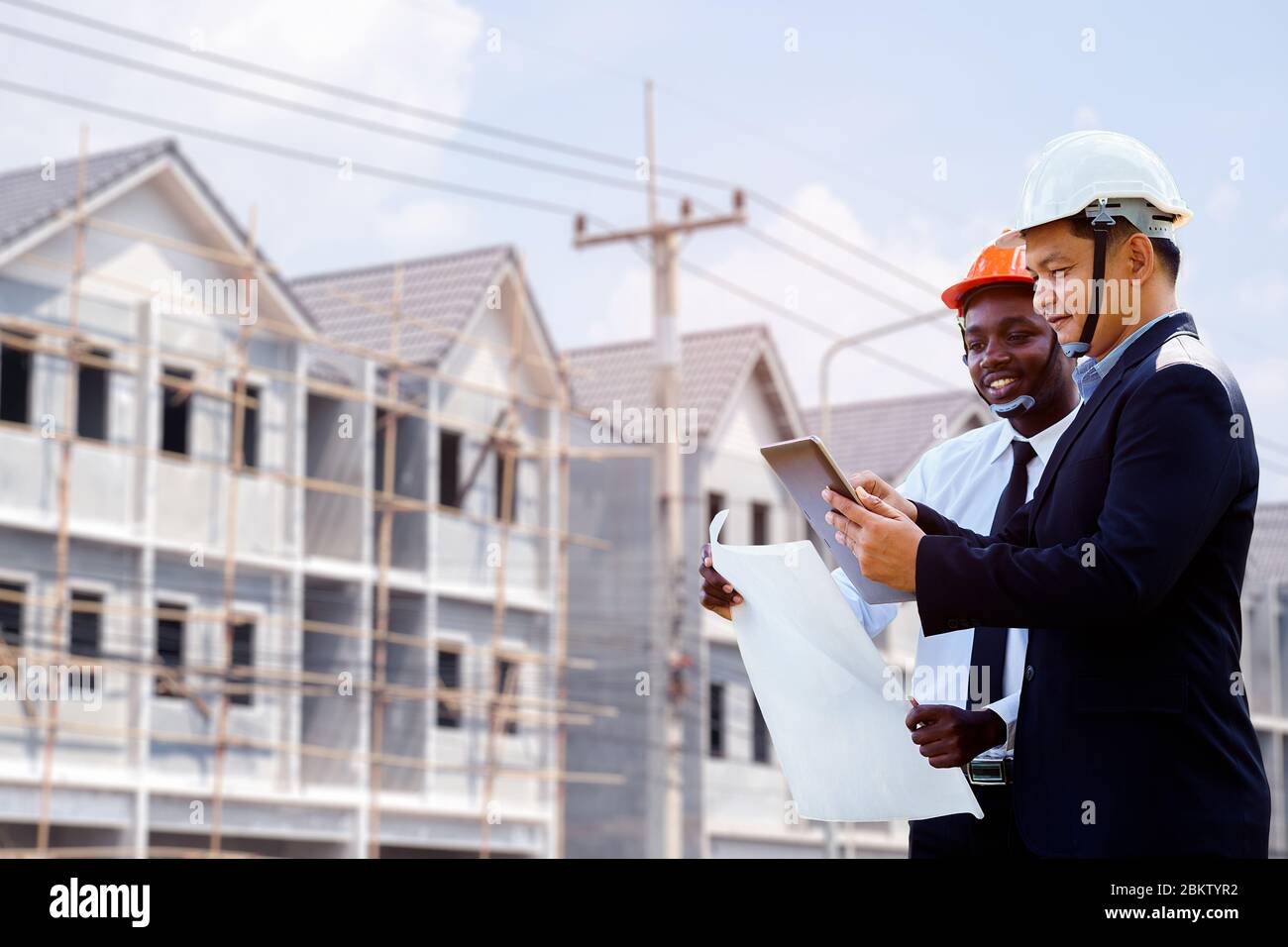 Asian and African architect engineer two expertise team plan with a ...