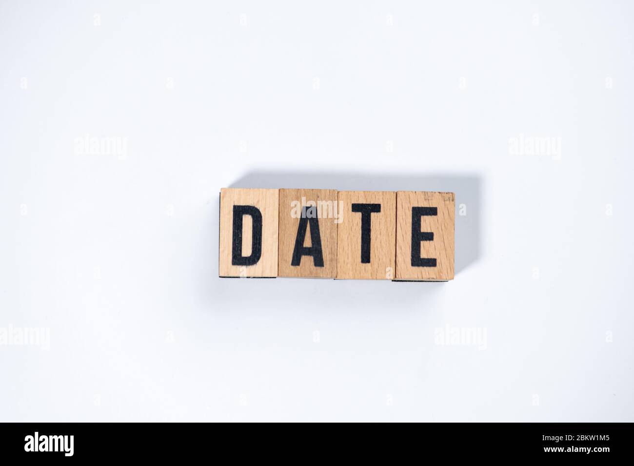 " DATE " text made of wooden cube on White background Stock Photo - Alamy