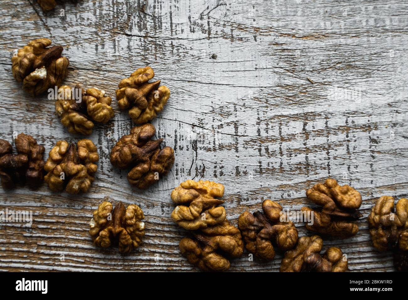Walnut scattered on the wooden vintage table. Walnuts is a healthy ...