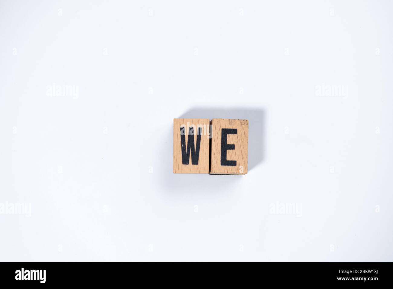" WE " text made of wooden cube on White background Stock Photo - Alamy