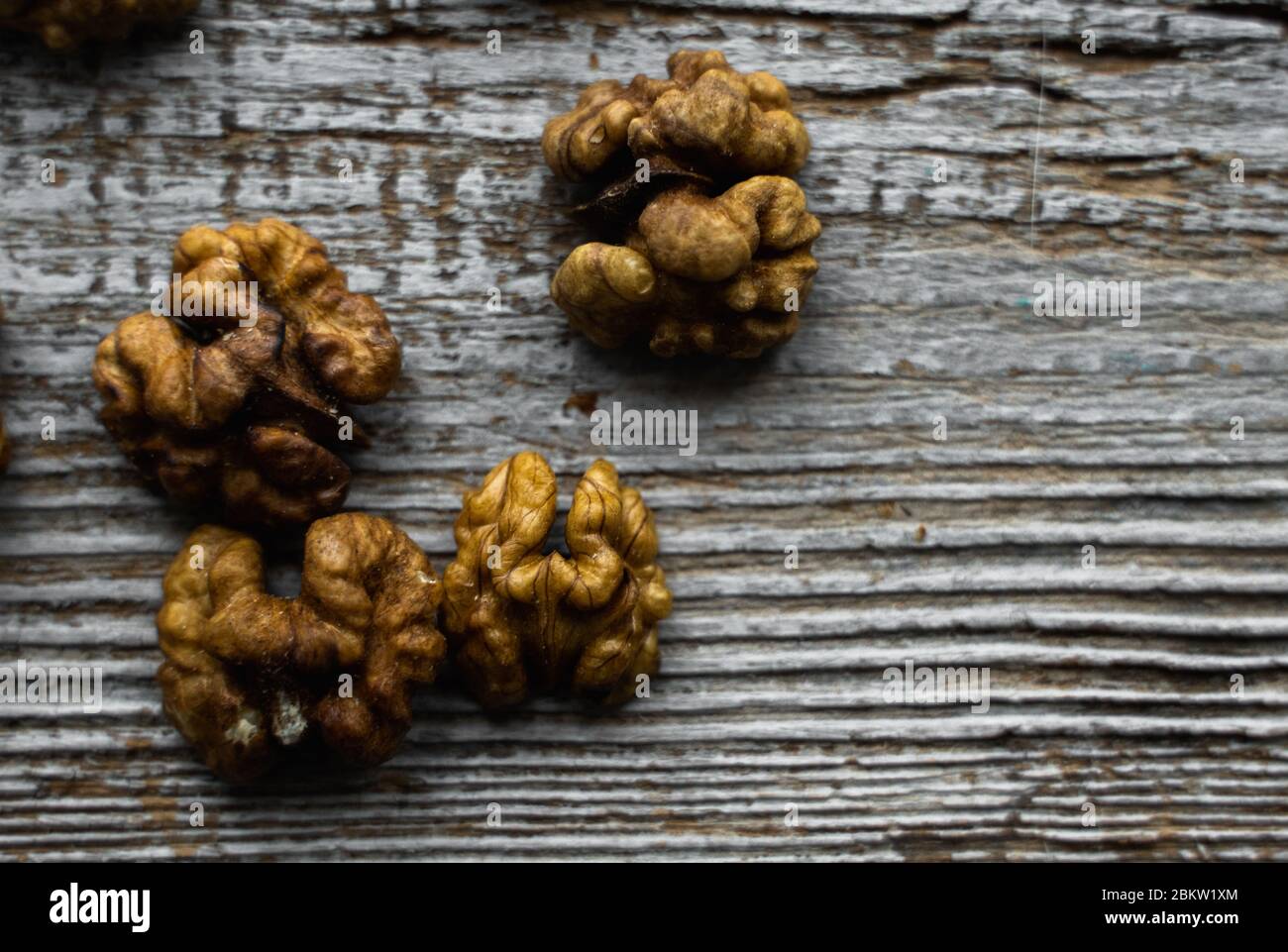 Walnut scattered on the wooden vintage table. Walnuts is a healthy ...