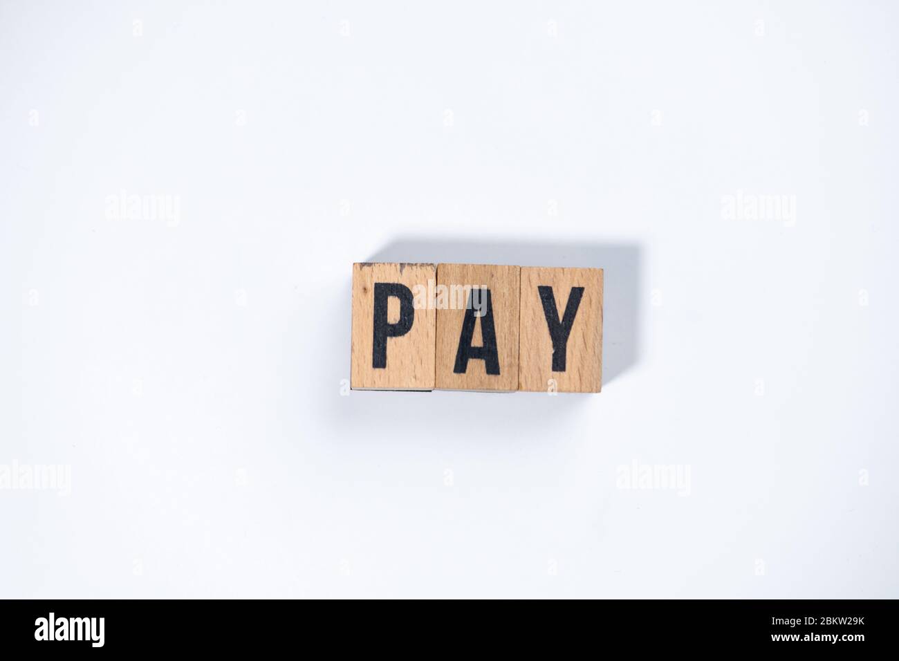 " PAY " text made of wooden cube on White background Stock Photo - Alamy