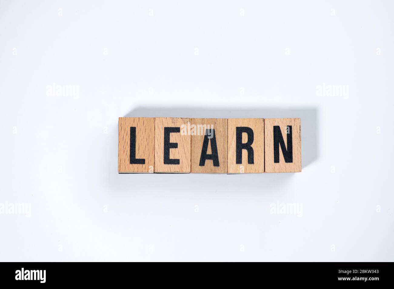 " LEARN " text made of wooden cube on White background Stock Photo - Alamy