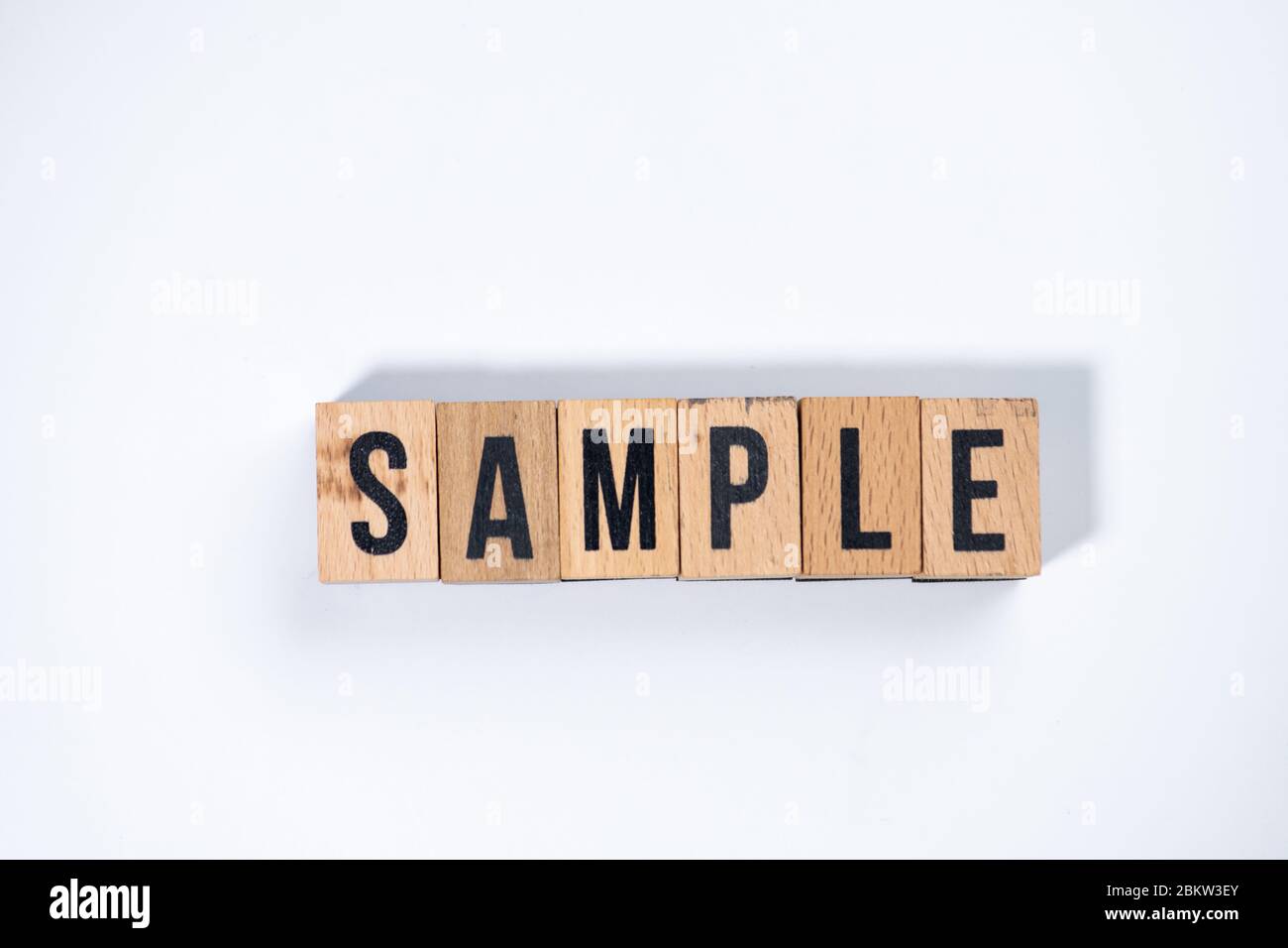 " SAMPLE " text made of wooden cube on White background Stock Photo - Alamy