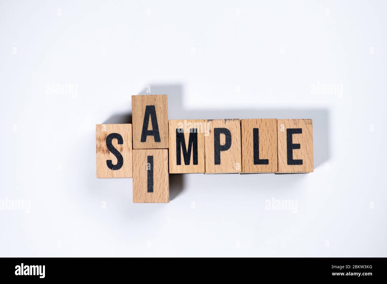 " SAMPLE " text made of wooden cube on White background Stock Photo - Alamy