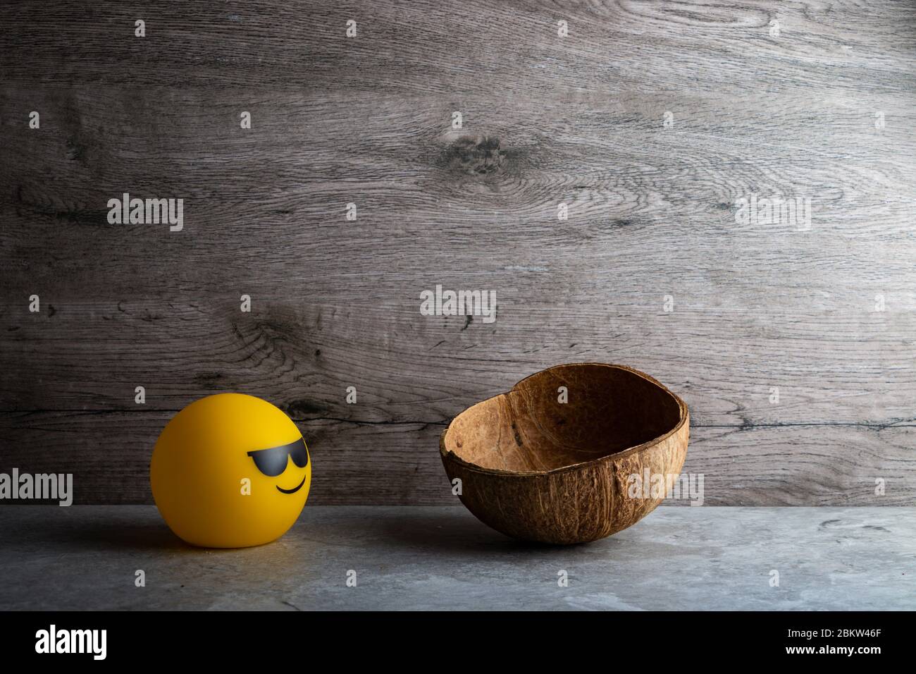 Coconut shell with smile lamp on tile background Stock Photo - Alamy