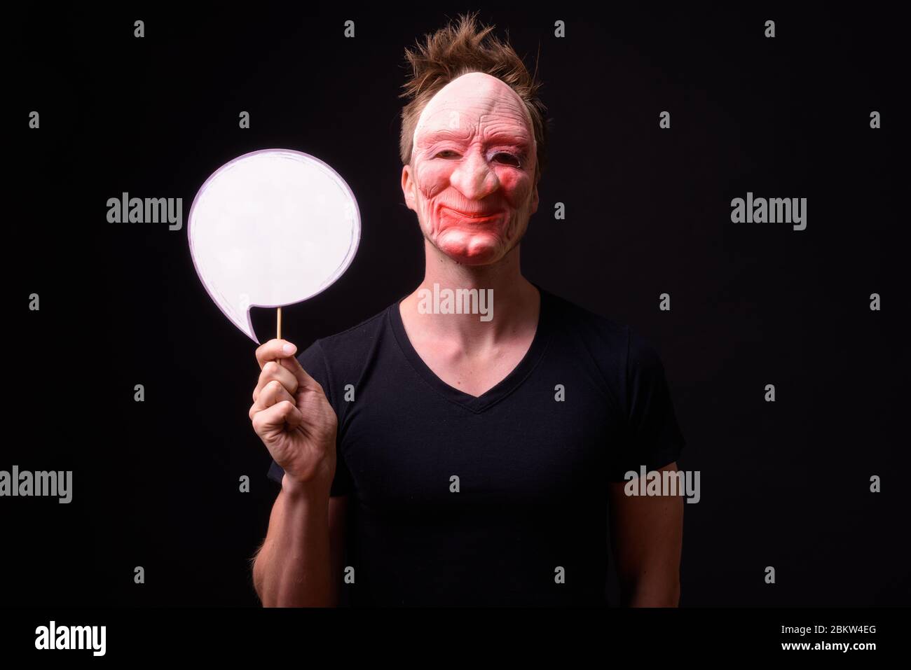 Portrait of young man wearing horror mask Stock Photo - Alamy
