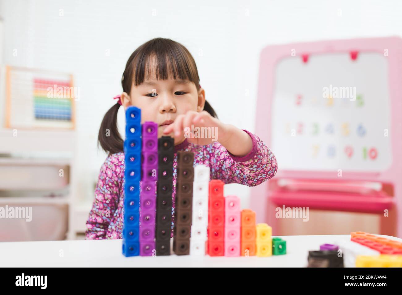toddler girl play number blocks for homeschooling Stock Photo - Alamy