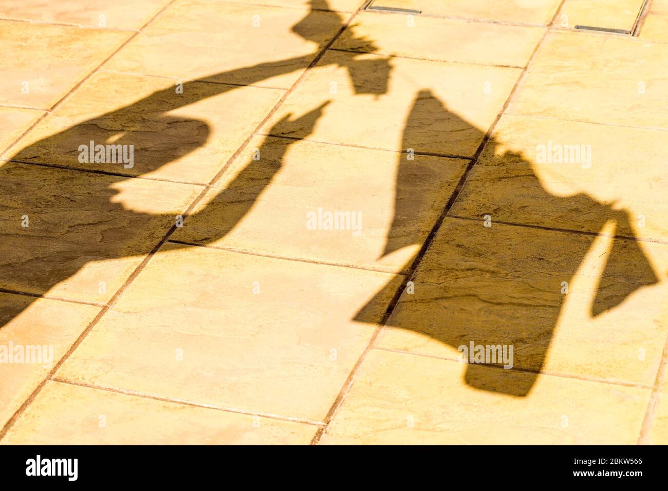 Sunlight shadow of man hang the clothes washing line at the garden ...