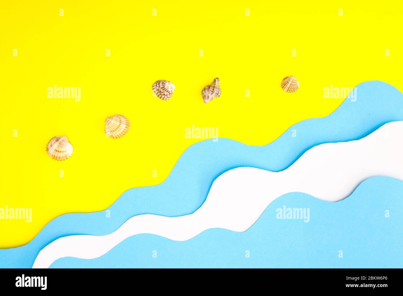 Sea shells and paper sea waves - hand made Stock Photo - Alamy