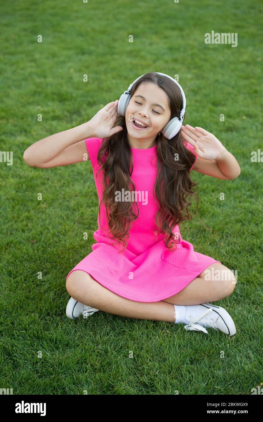 Practicing her singing. Happy singer sing song outdoors. Little girl ...