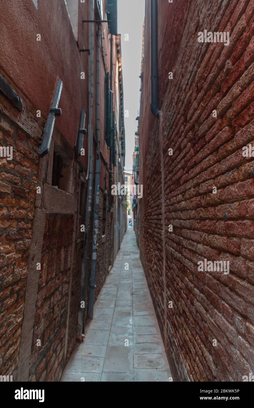 Really narrow alley with brickwalls on the sides in Venice. High ...