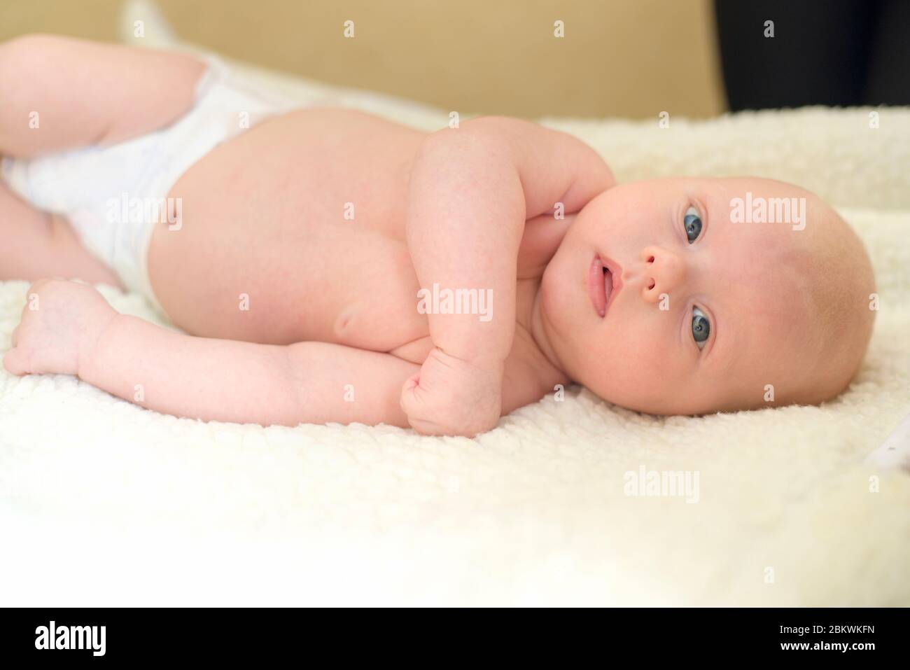 Portrait of a cute newborn baby lying on his side Stock Photo - Alamy