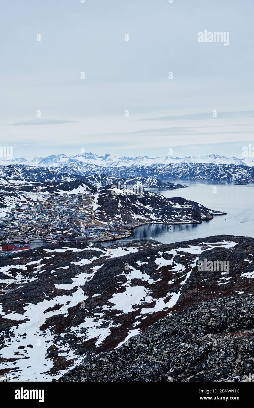 City of Qaqortoq in Greenland with mountain ranges visible behind Stock ...