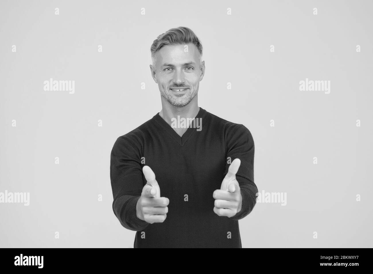 Only you. Handsome guy pointing yellow background. Happy man pointing ...