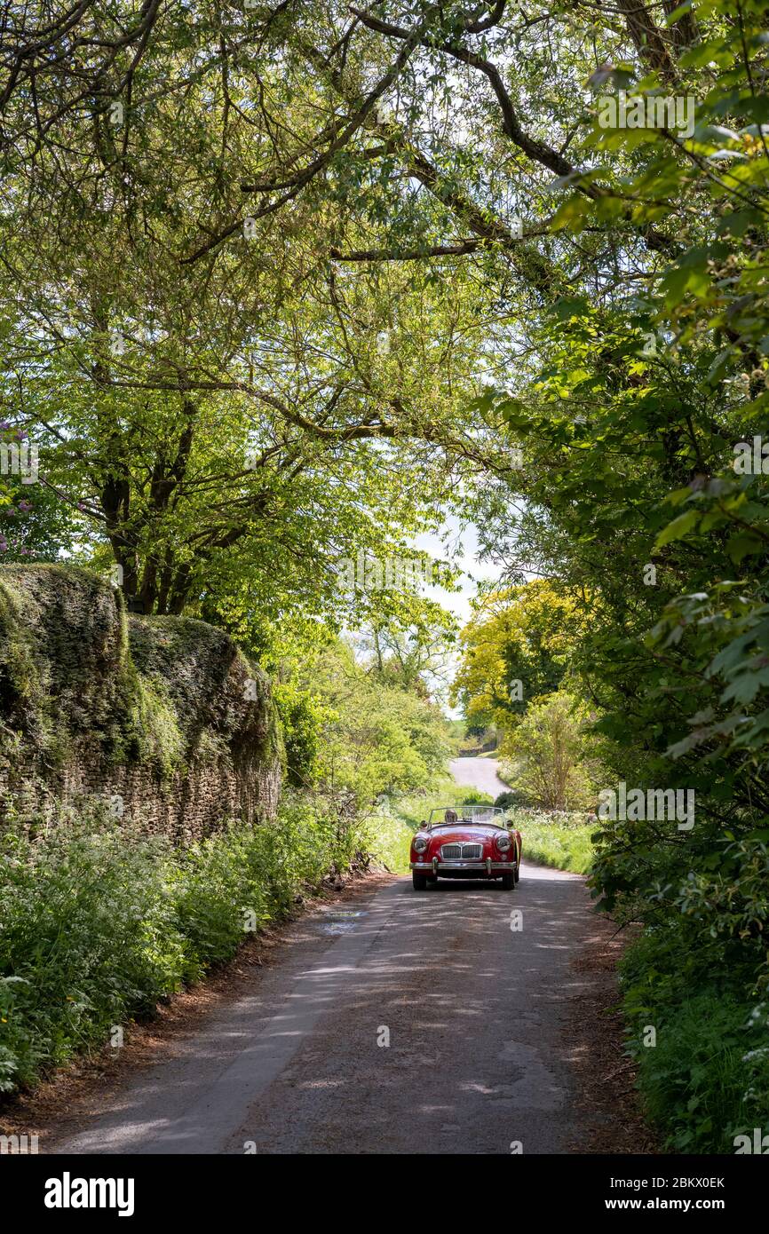 Man driving open top convertible MG sports car in The Cotswolds, UK ...