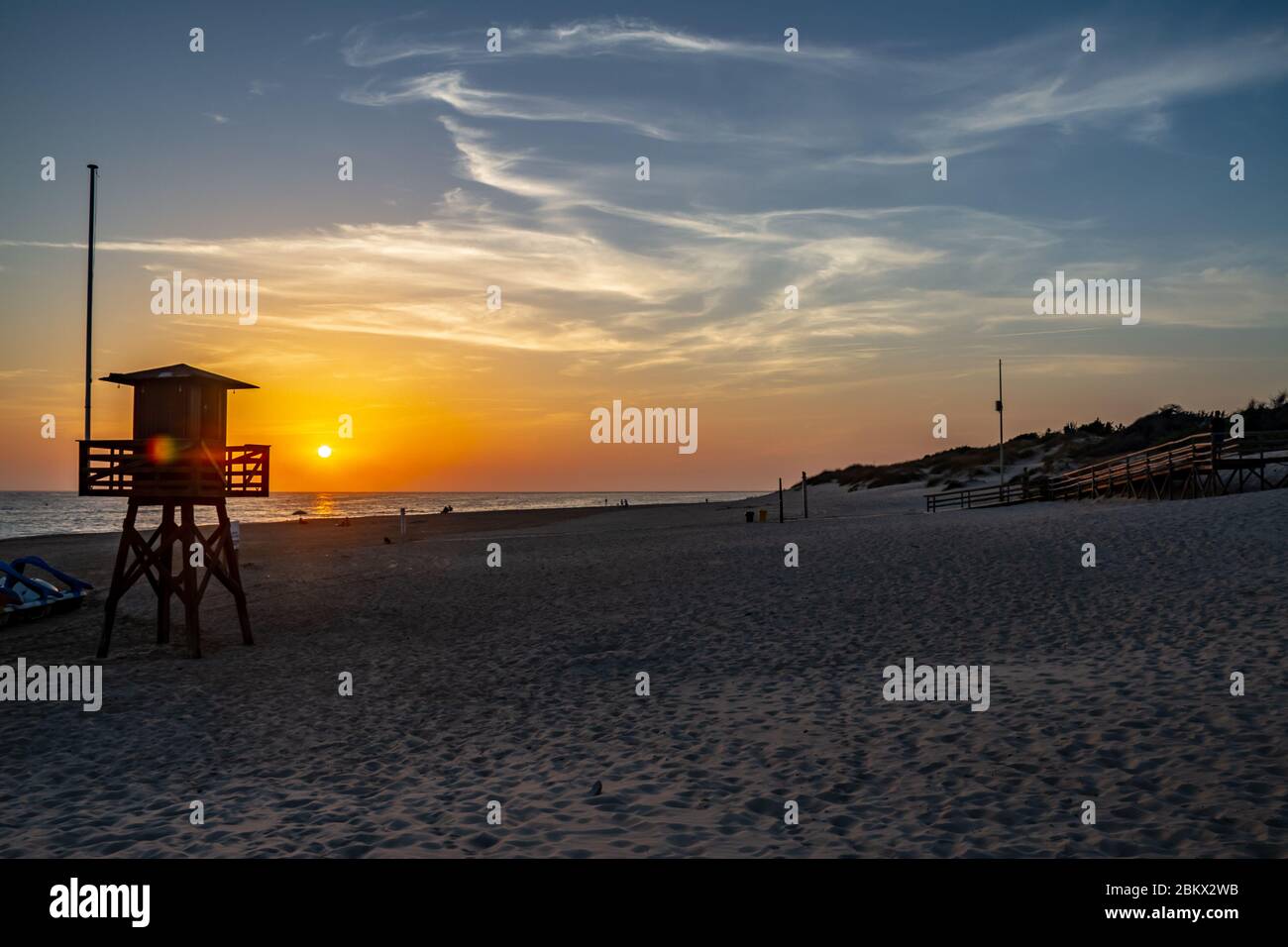 Sun Setting Behind Lifeguard Tower Stock Photo - Alamy