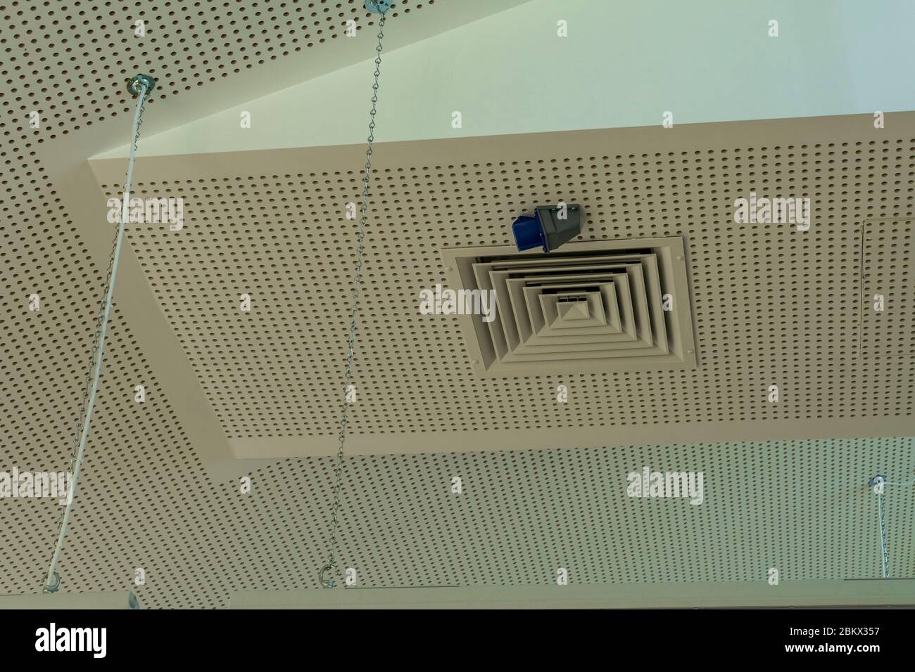 White sound absorption ceiling with duct grilles and lights Stock Photo ...