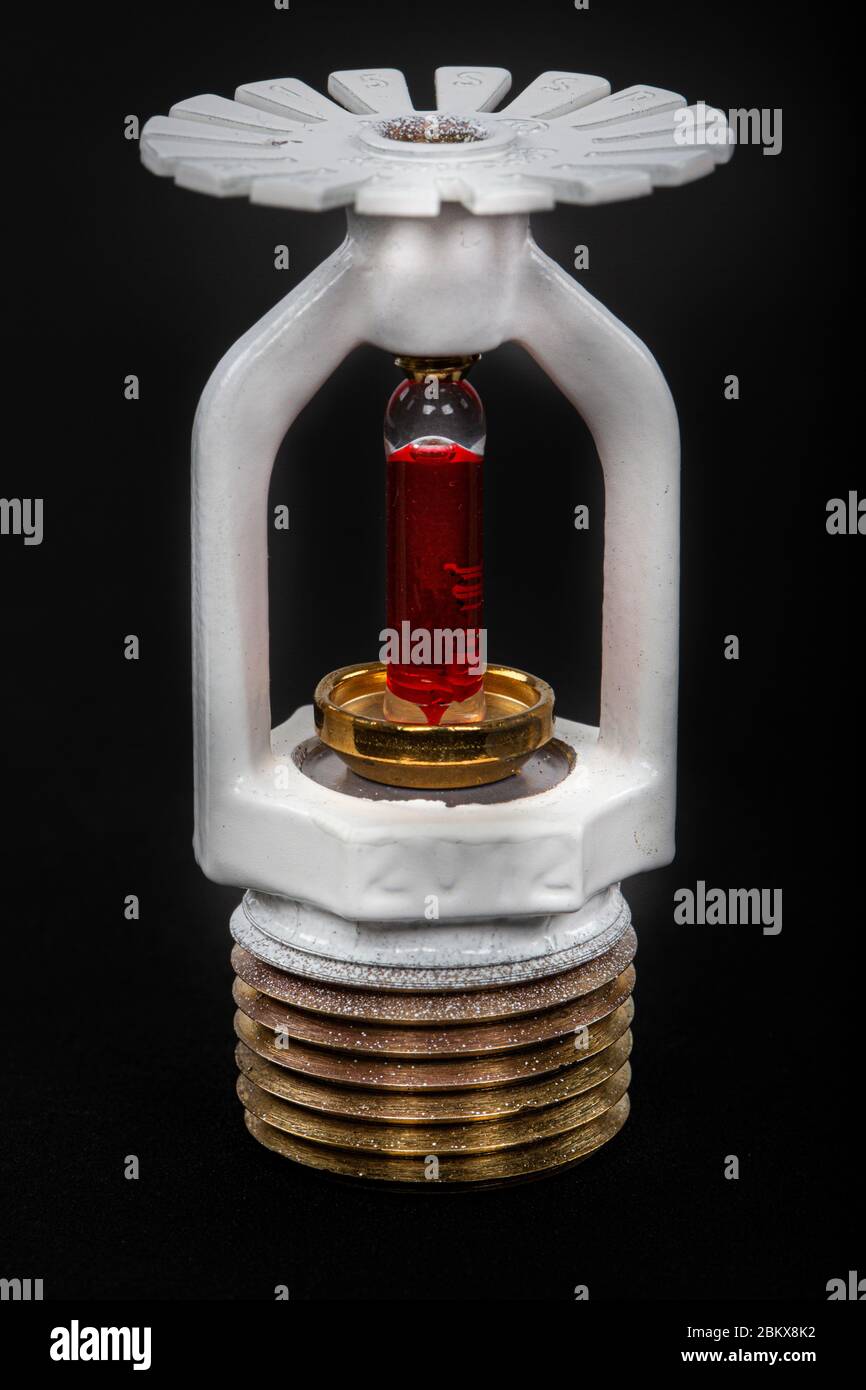 Close up image of fire sprinkler with fire in background. Fire ...