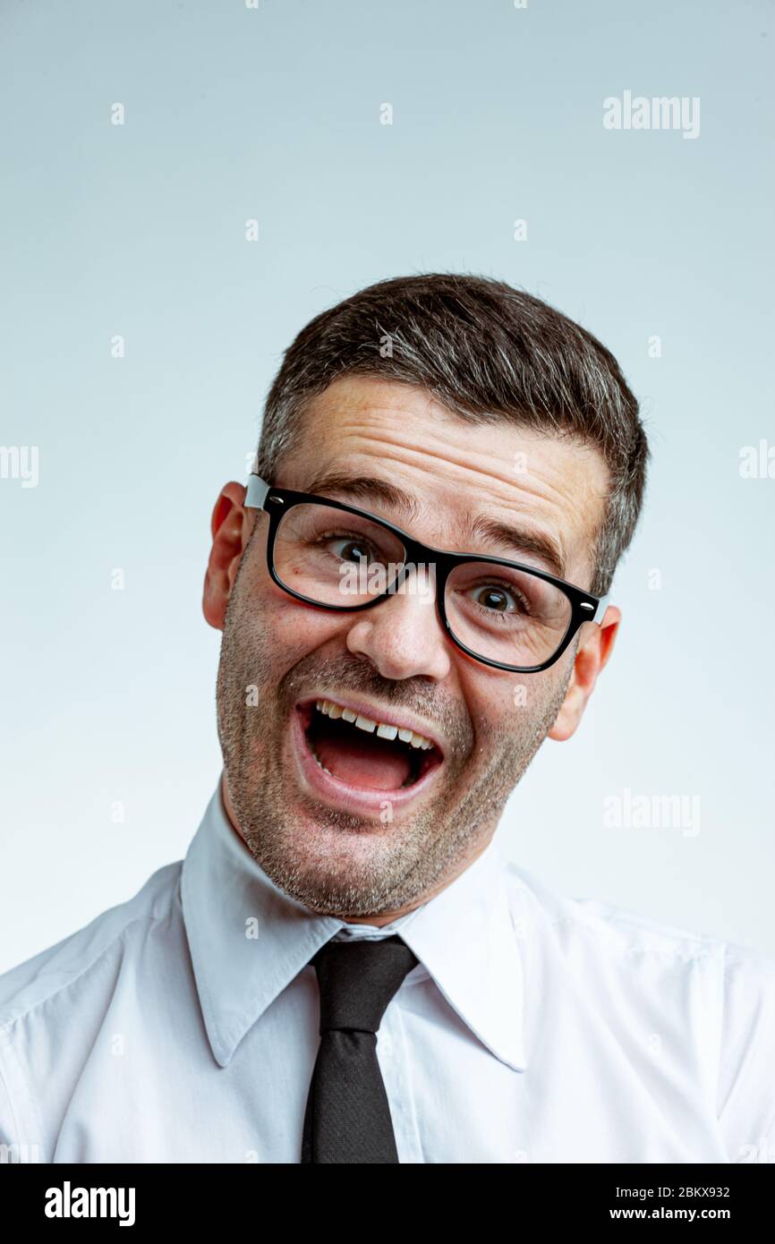 Funny and crazy laughing businessman with unshaven face, wearing ...