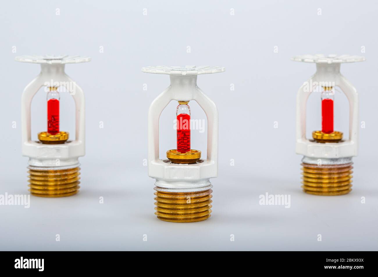 Close up image of fire sprinkler with fire in background. Fire ...