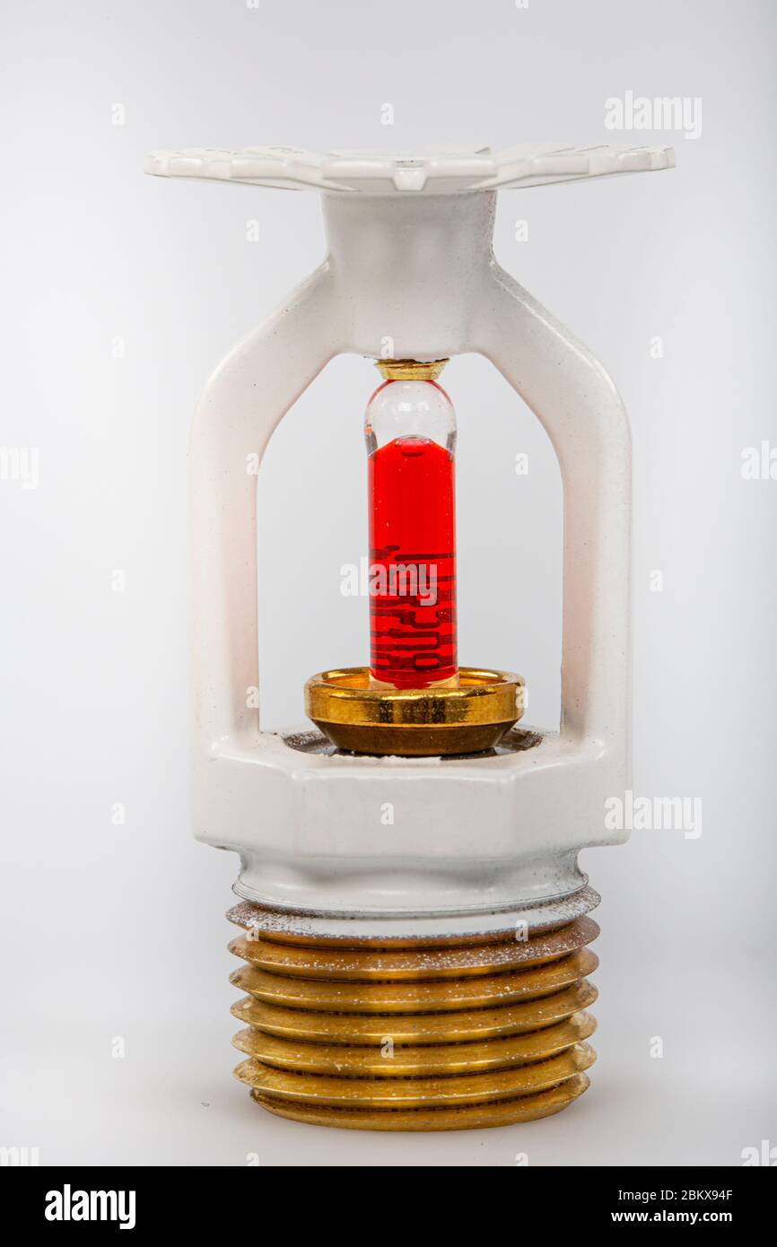 Close up image of fire sprinkler with fire in background. Fire ...