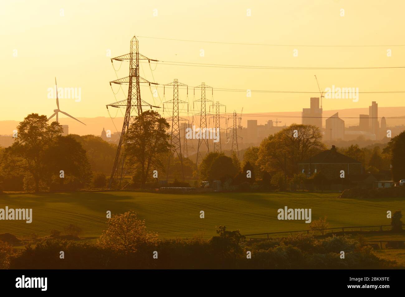 Sunset behind Leeds skyline with pylons from the National Grid at ...