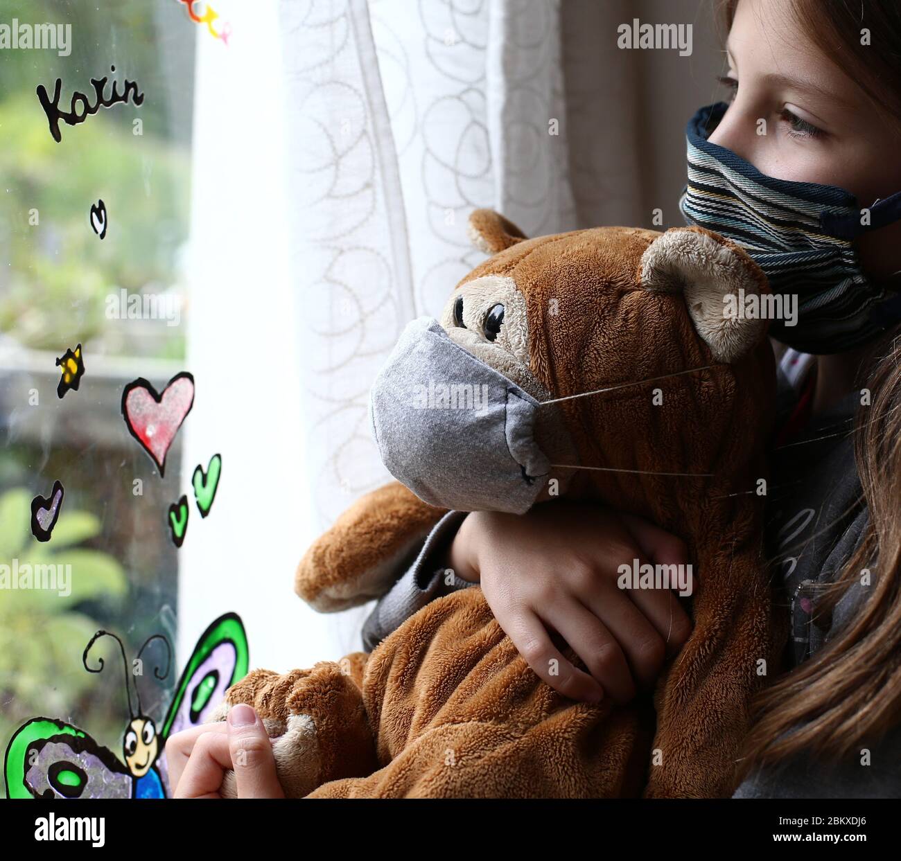 Karin Teyssot and her Teddy Bear wear face masks amid the global ...