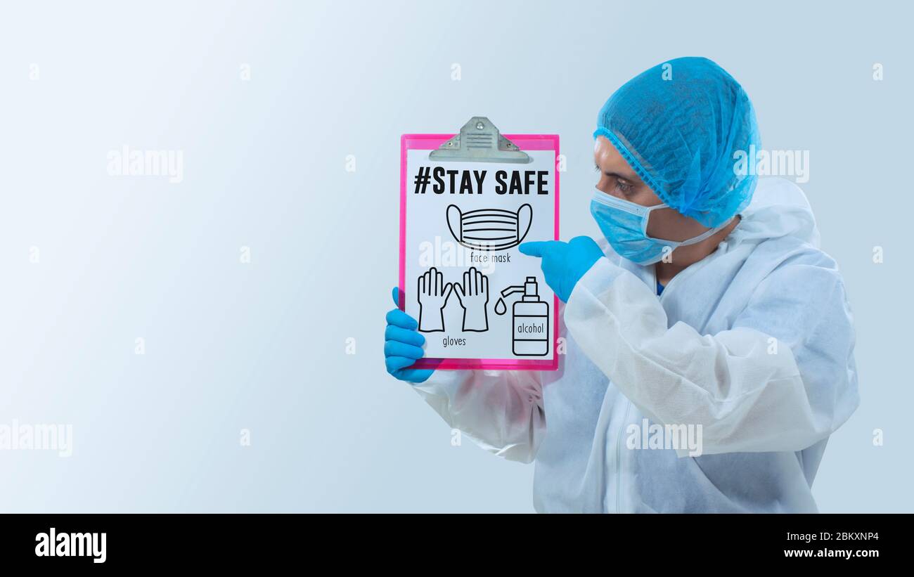 Doctor looking straight ahead with mask and blue gloves holding with ...