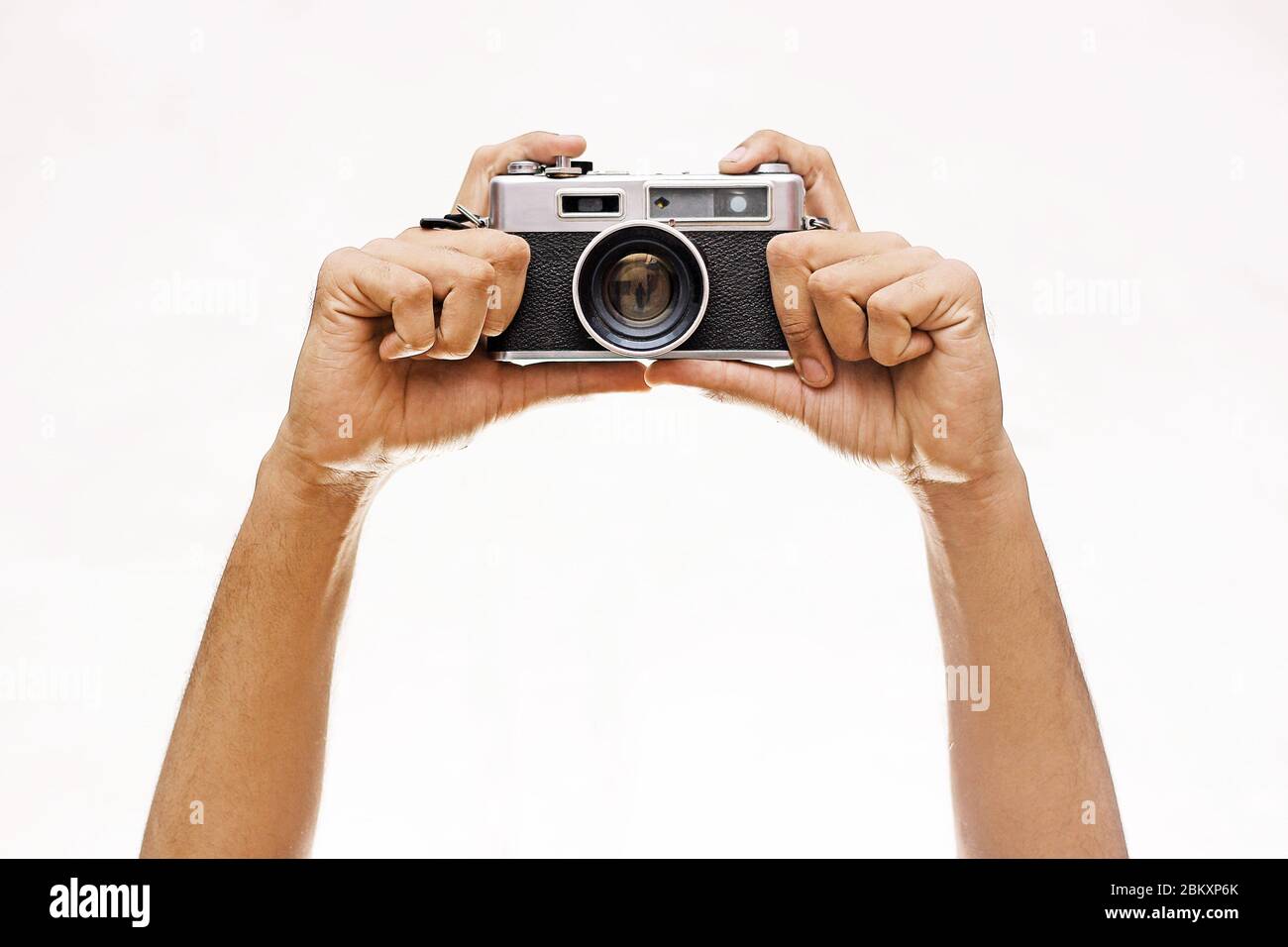 Two hand holding a vintage camera isolated on white background Stock ...