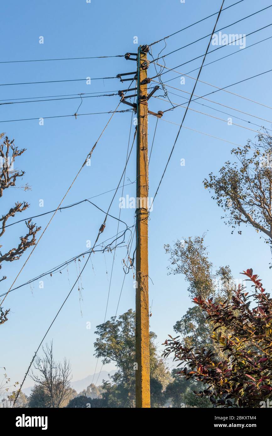 Concrete electrical three phase pole with messy wires Stock Photo - Alamy
