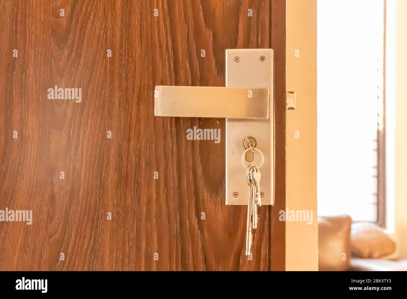 Door lock handle with set of keys hanging with door Stock Photo - Alamy