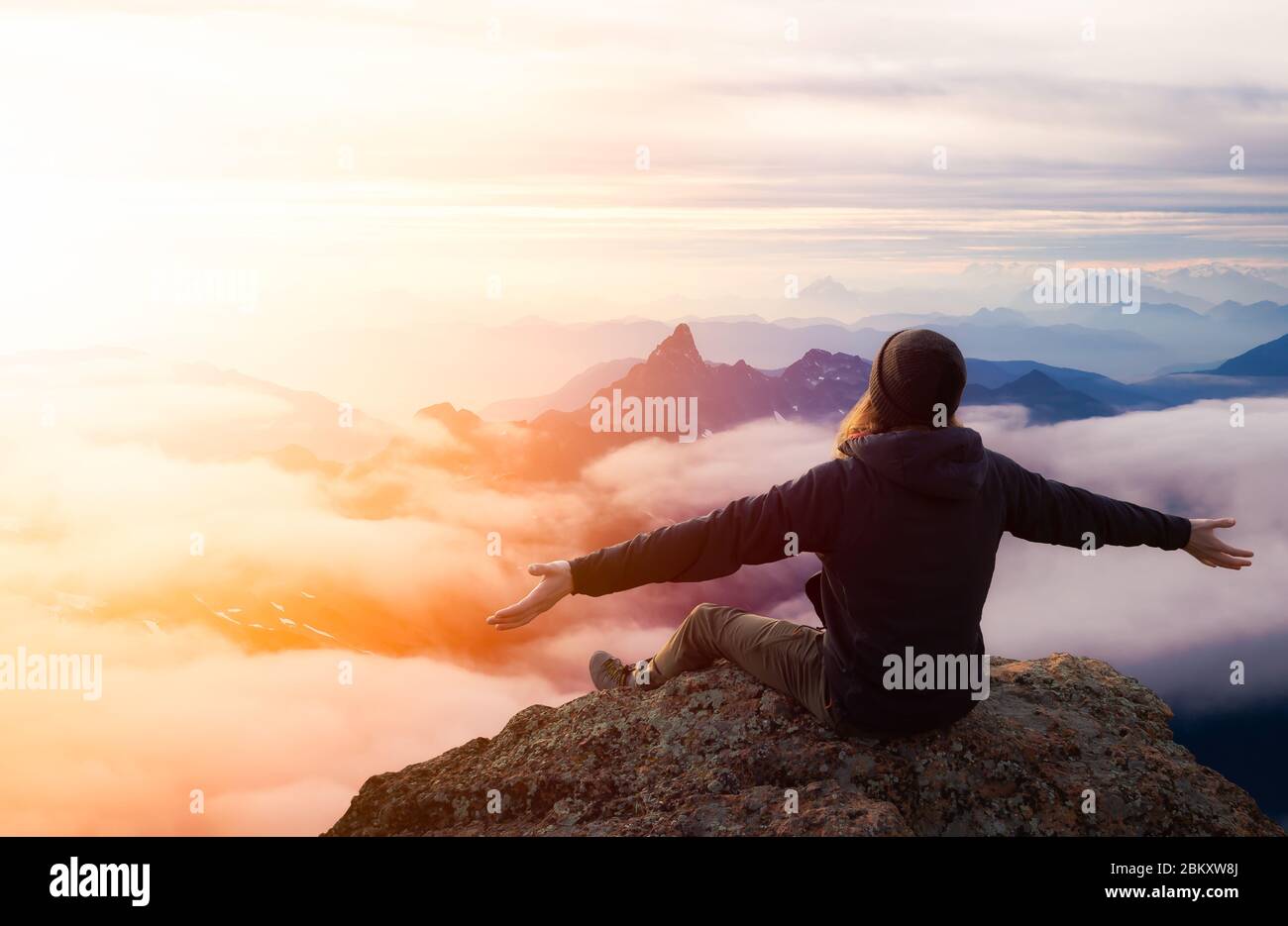 Adventurous Man with Open Hands in the mountains Stock Photo - Alamy