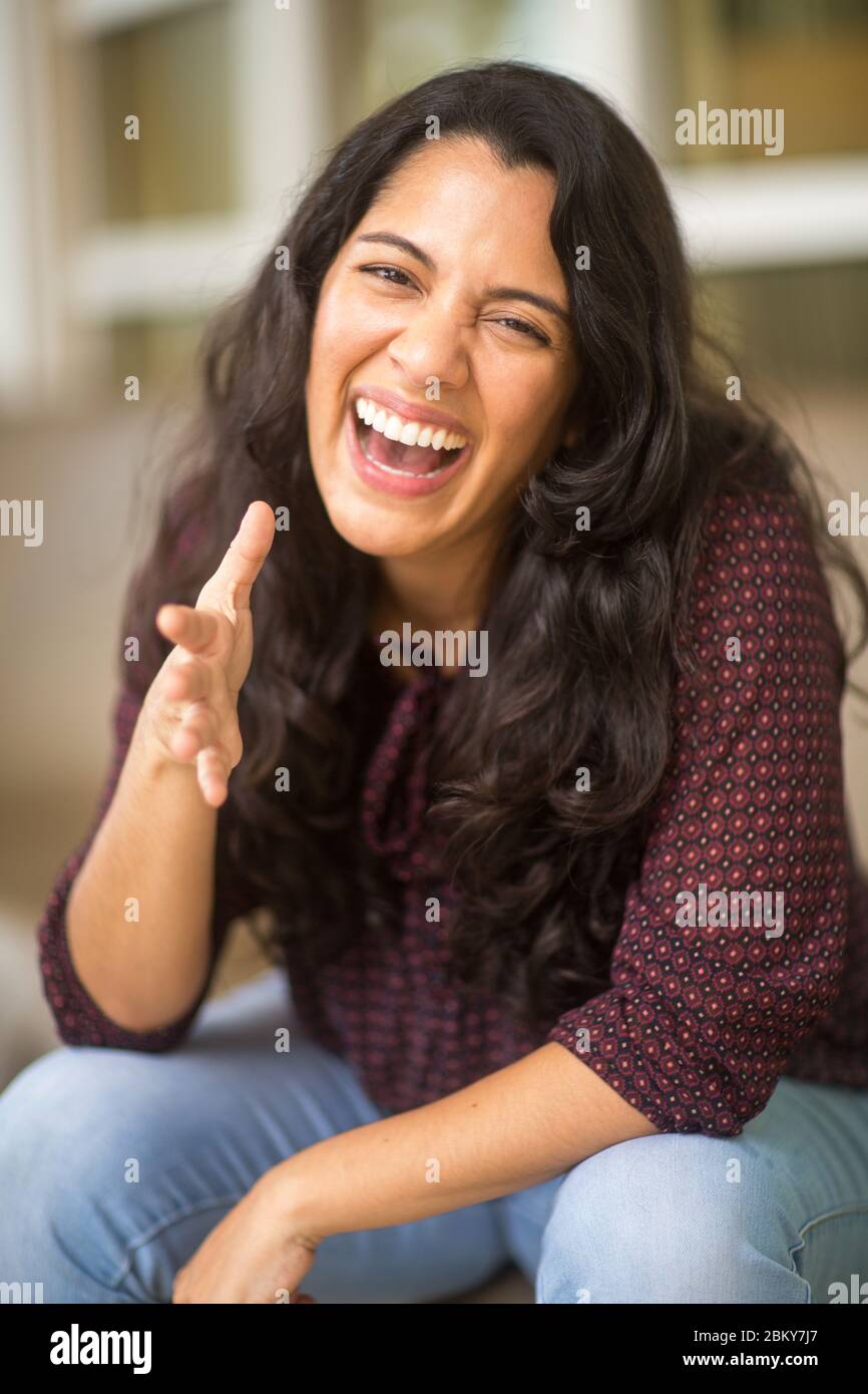 Confident Hispanic woman laughing and smiling stock photo Stock Photo ...