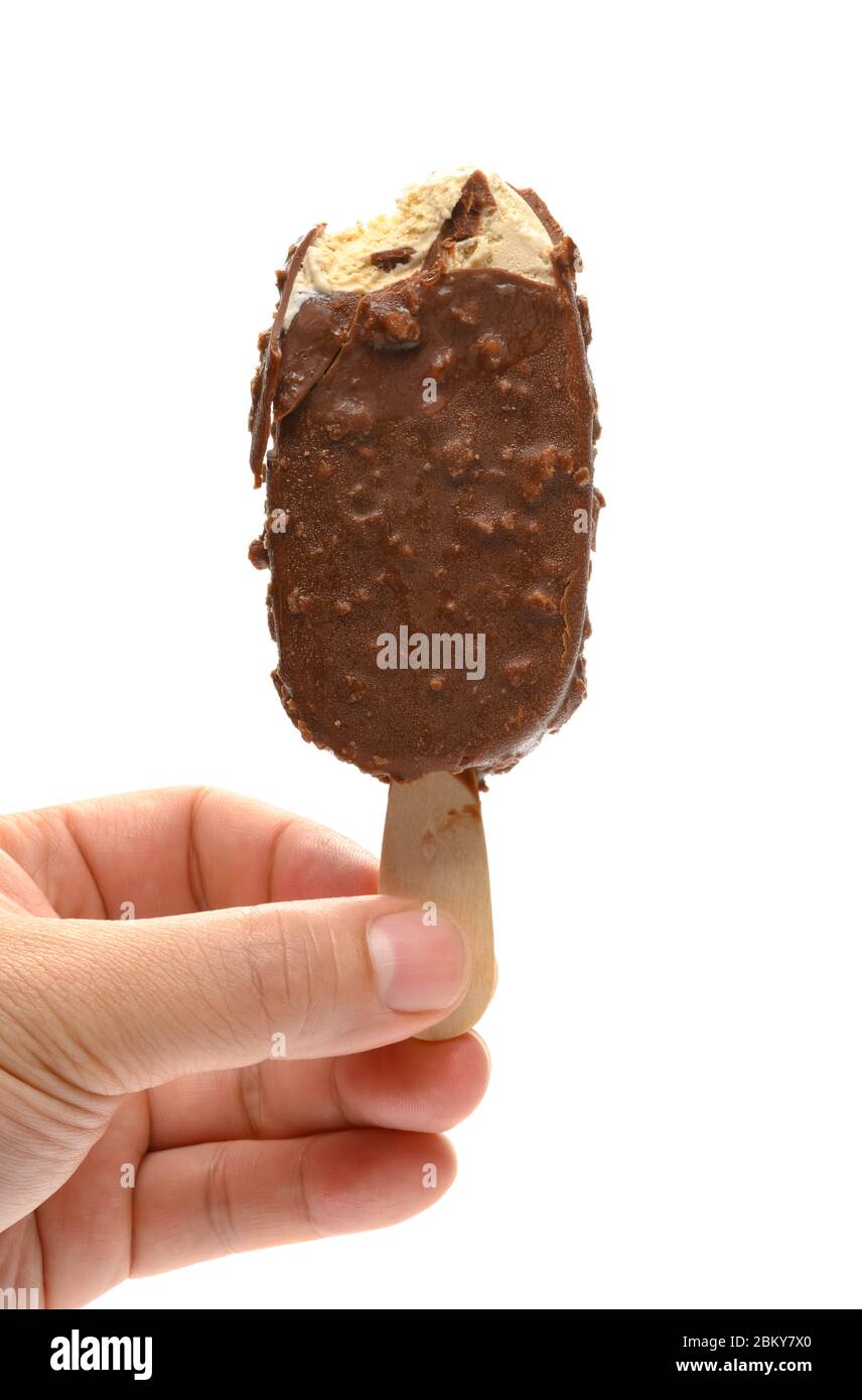 hand holding a chocolate and coffee flavor popsicle with a bite on ...