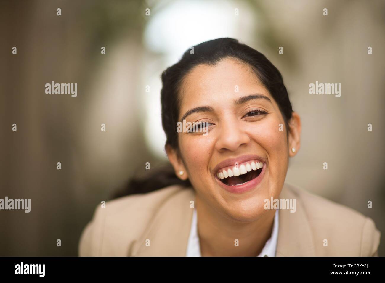 Hispanic business woman smiling outside stock photo Stock Photo - Alamy