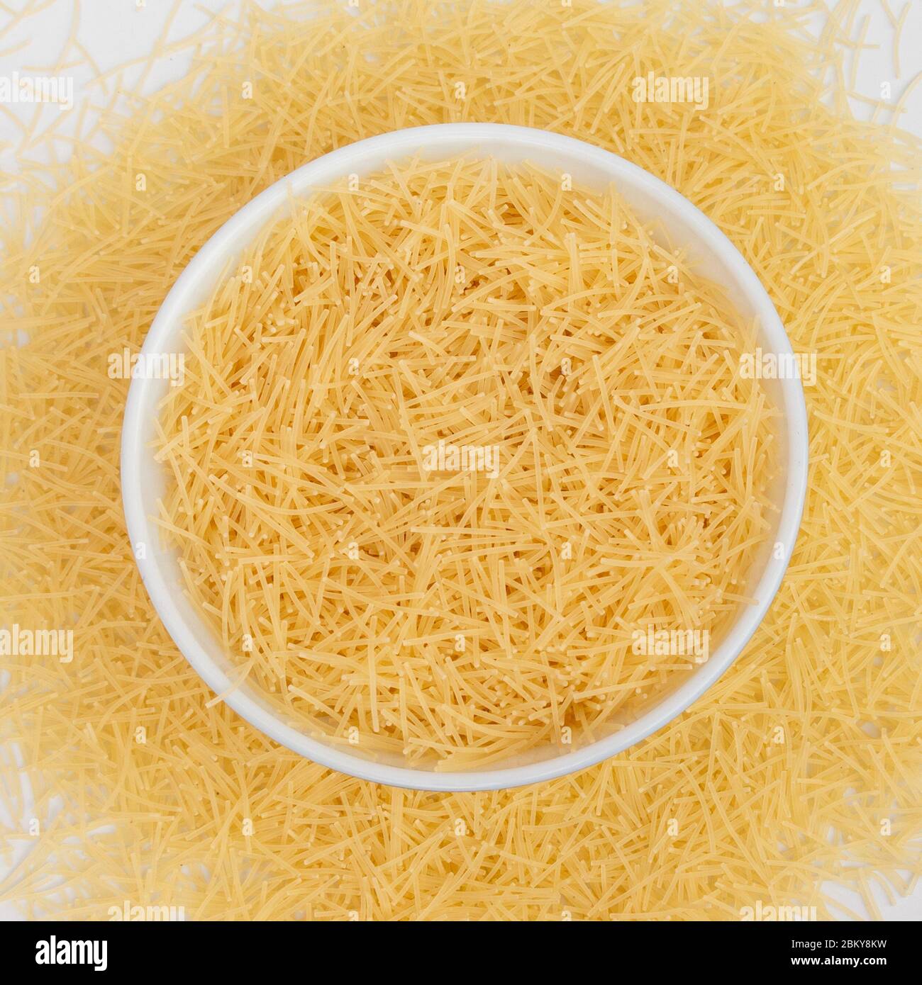 Raw vermicelli pasta in a bowl isolated on white background Stock Photo ...