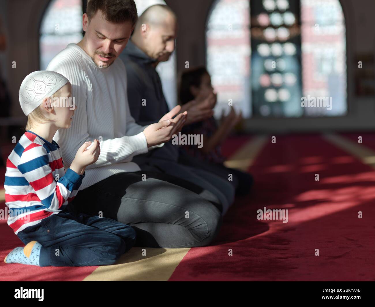 muslim prayer father and son in mosque praying Allah Stock Photo - Alamy