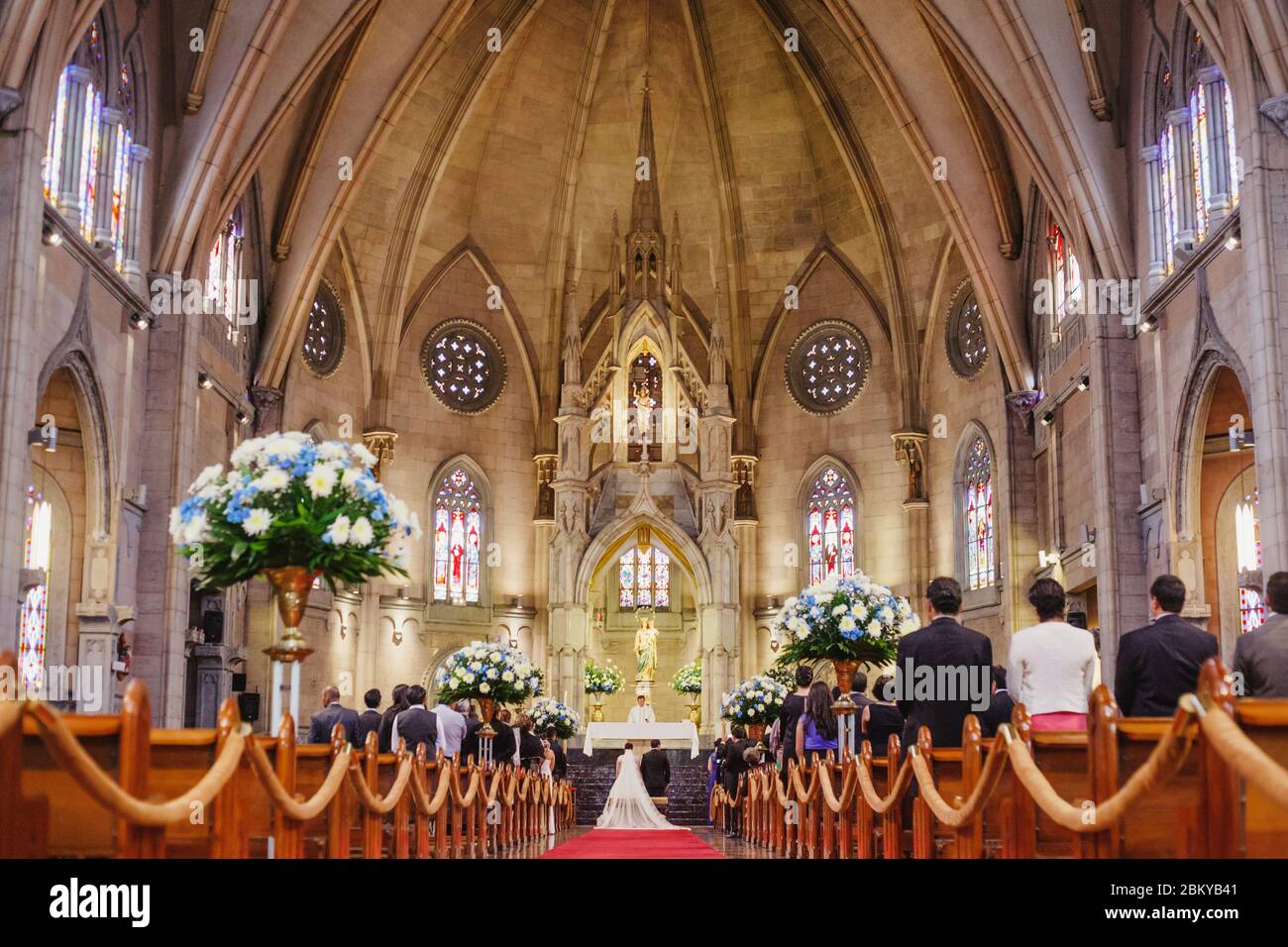 couple getting married in a beautiful gothic church Stock Photo - Alamy