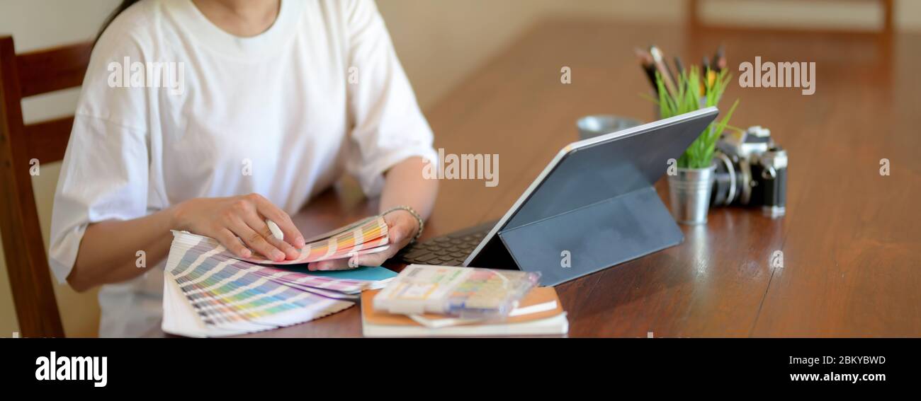 Cropped shot of female university student working on her project and ...
